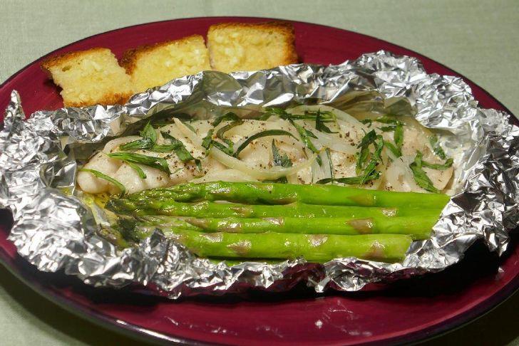 Savor the aroma of tarragon-seasoned steamed fish parcels with garlic ...